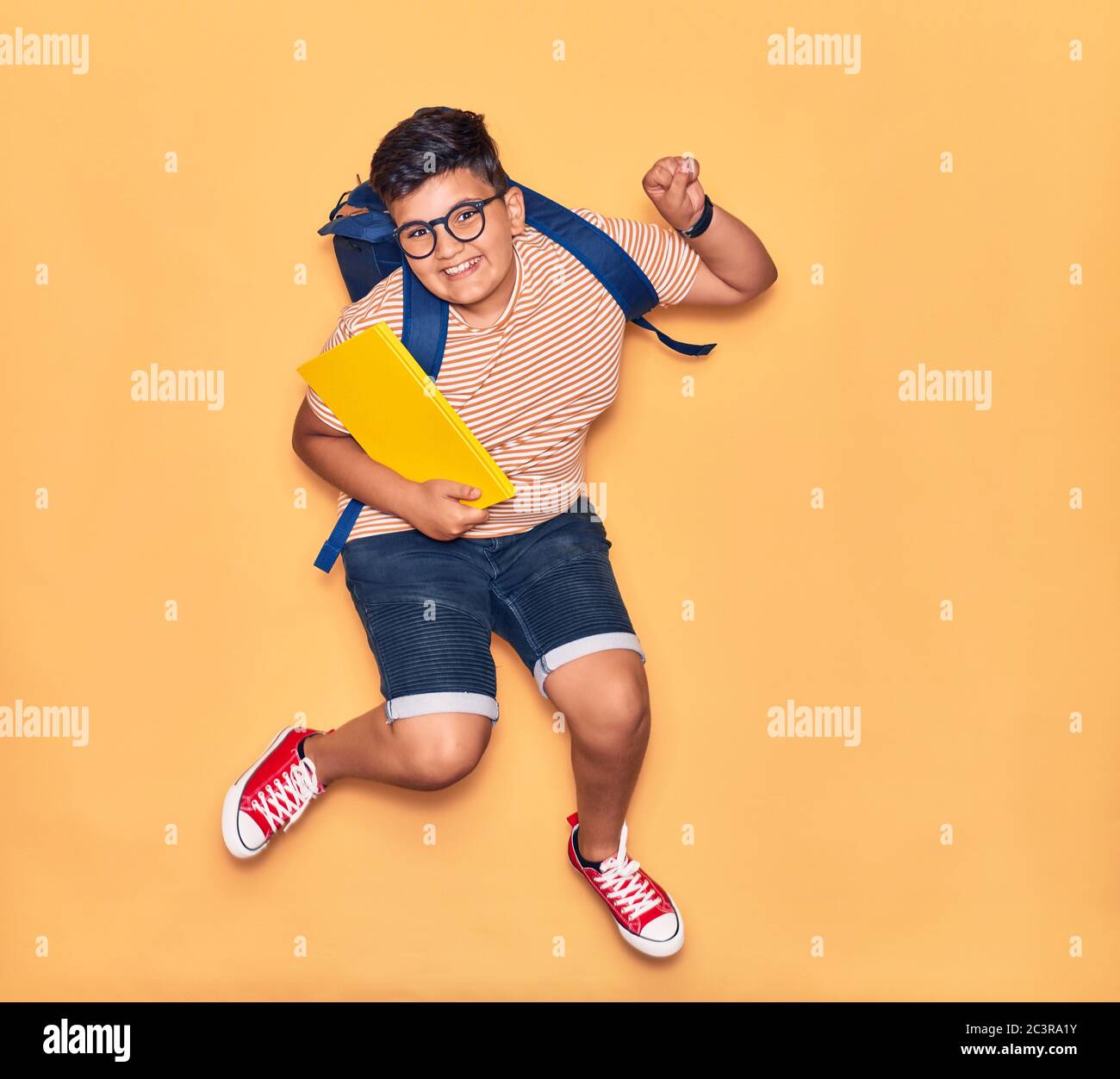 Adorable student boy wearing glasses and backpack smiling happy ...