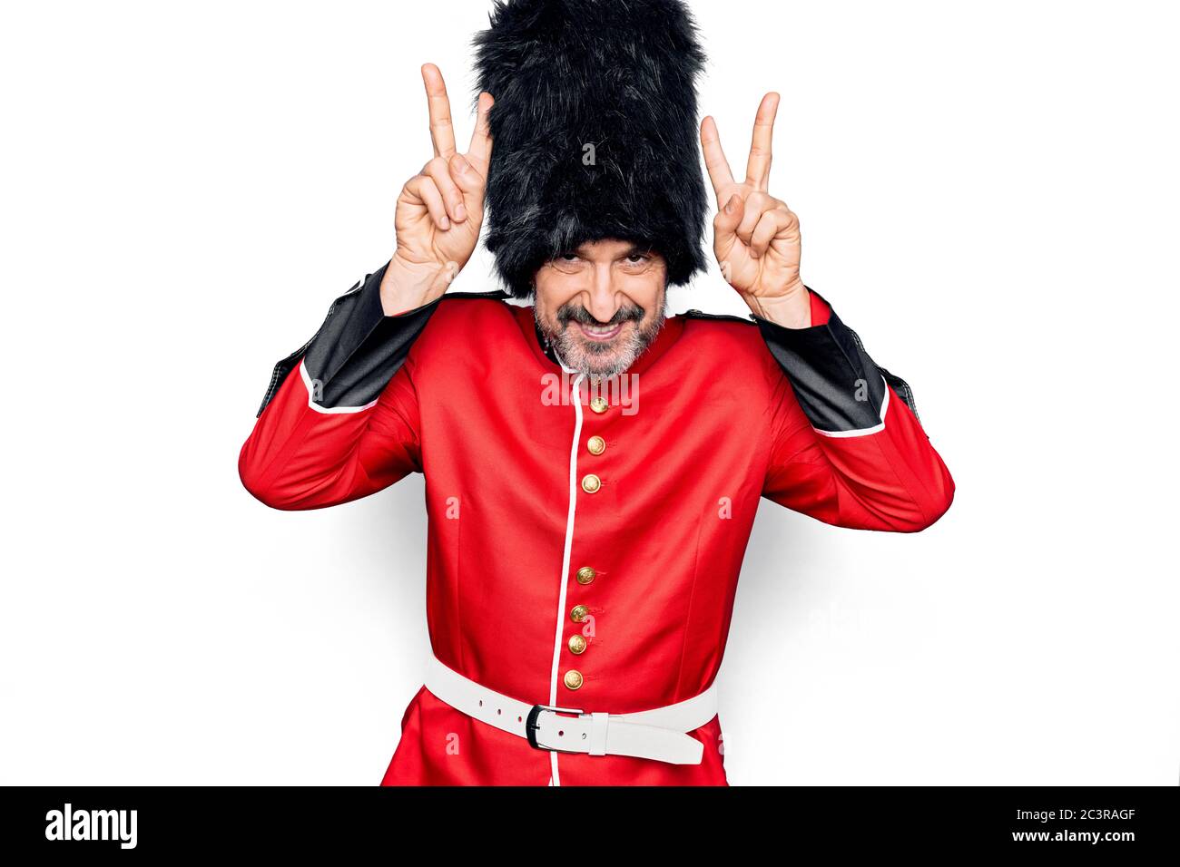 Middle age handsome wales guard man wearing traditional uniform over ...