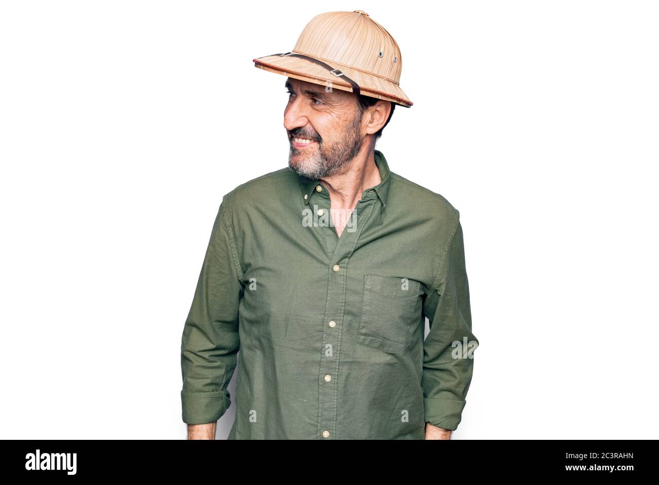 Middle age tourist man on vacation wearing explorer hat over isolated ...