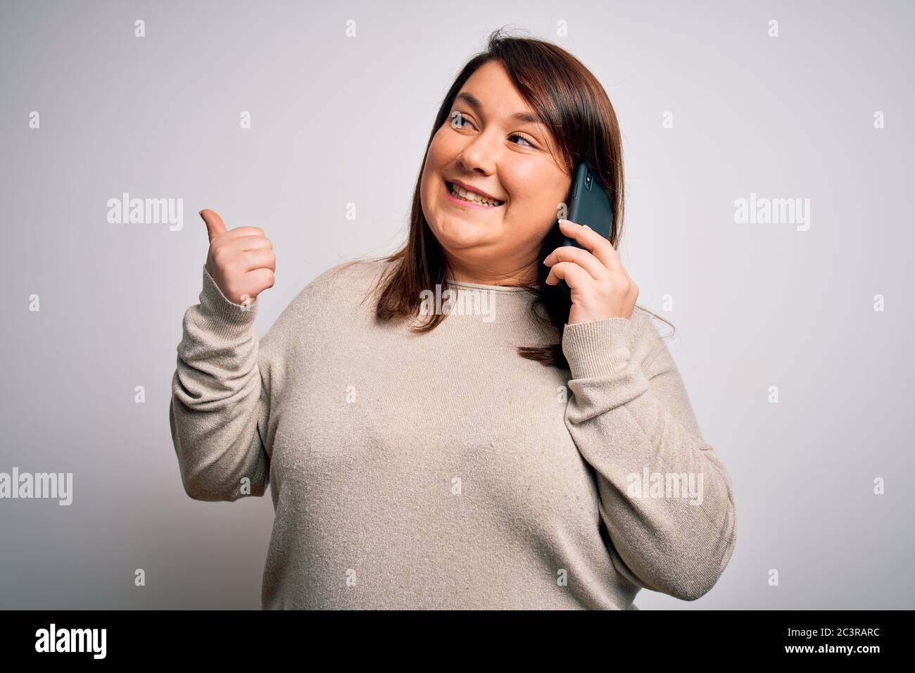 Beautiful plus size woman having a conversation talking on smartphone ...