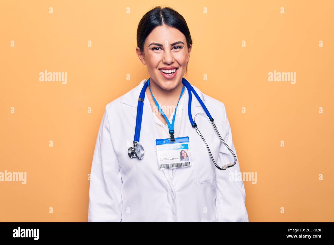 Young beautiful doctor woman wearing stethoscope and id card over ...