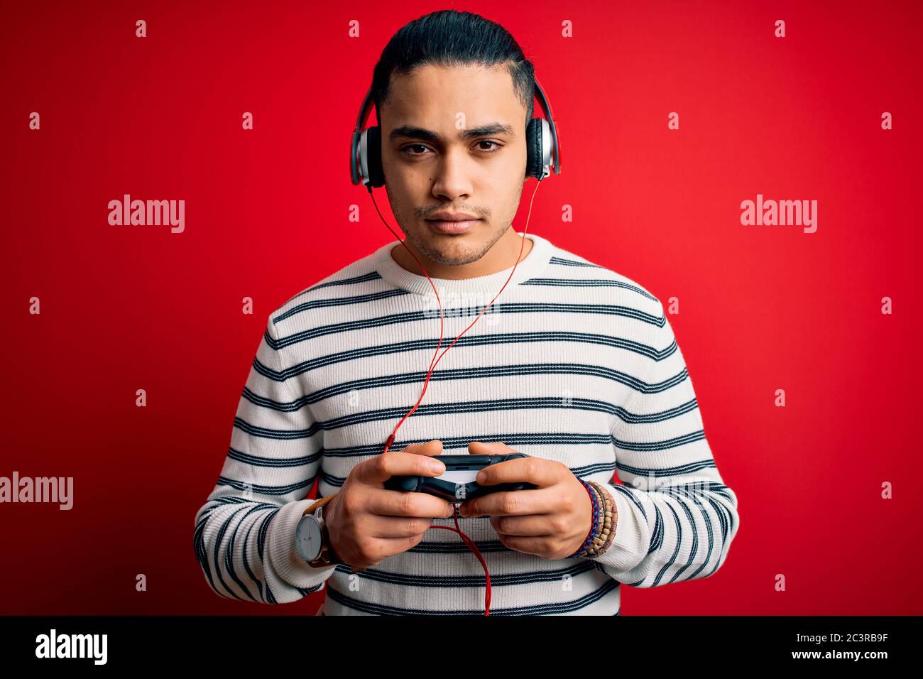 Young brazilian gamer man playing video game using joystick and ...
