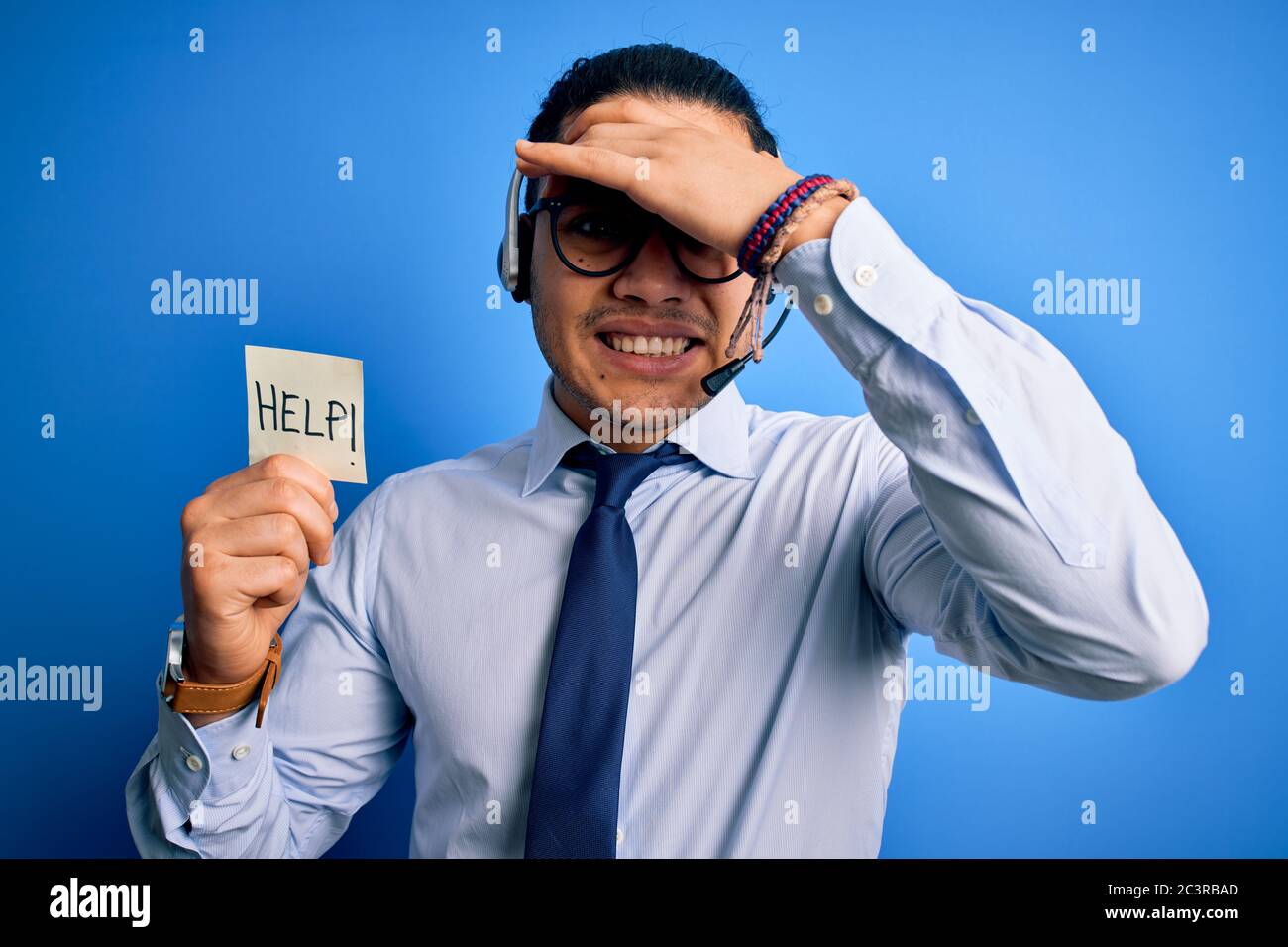 Young brazilian call center agent man overworked holding reminder paper ...