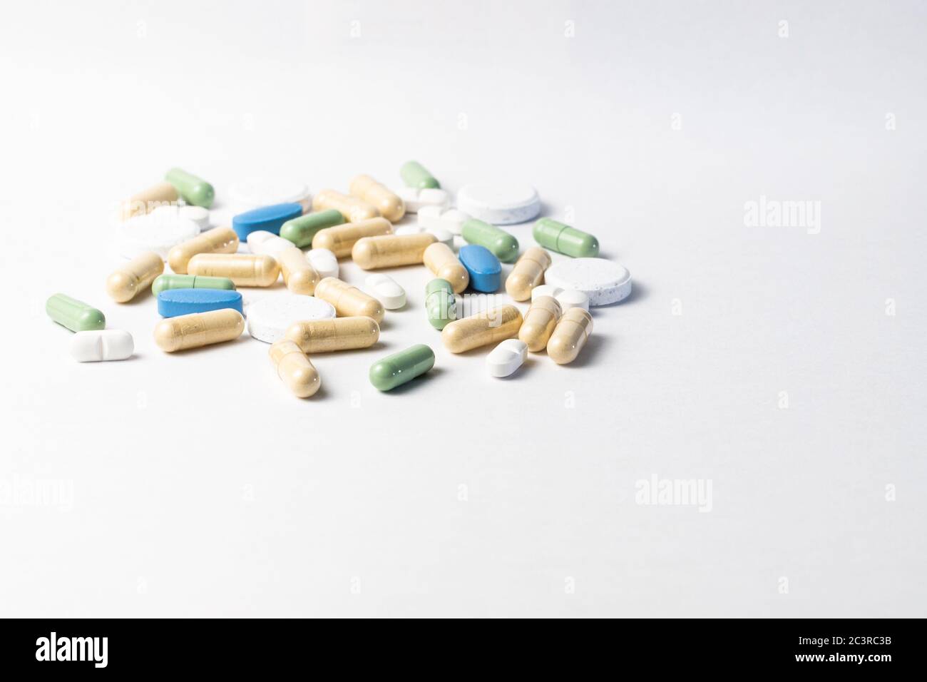 Pile of scattered capsules on a white background Stock Photo - Alamy