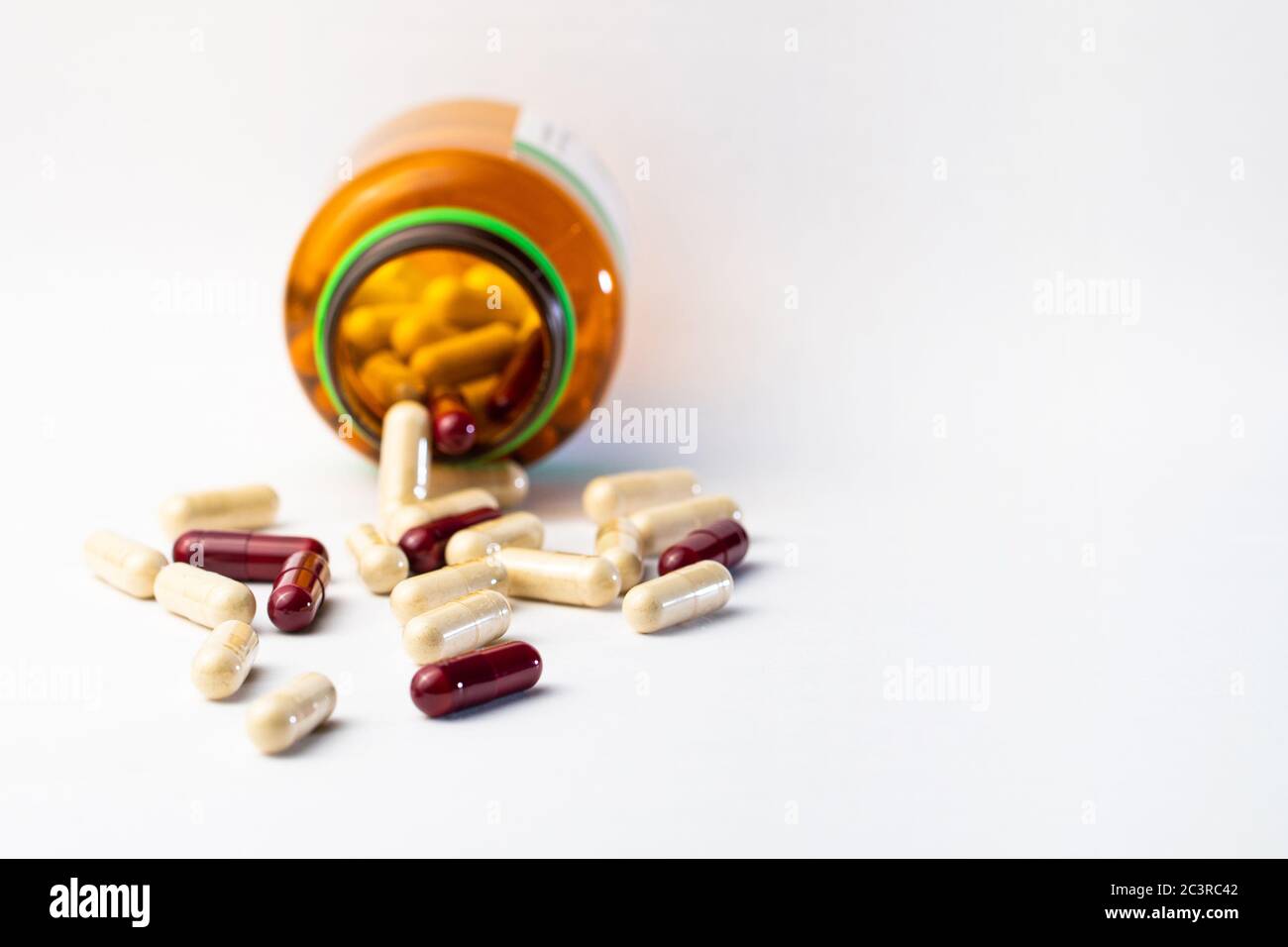 Pile of scattered capsules on a white background Stock Photo - Alamy
