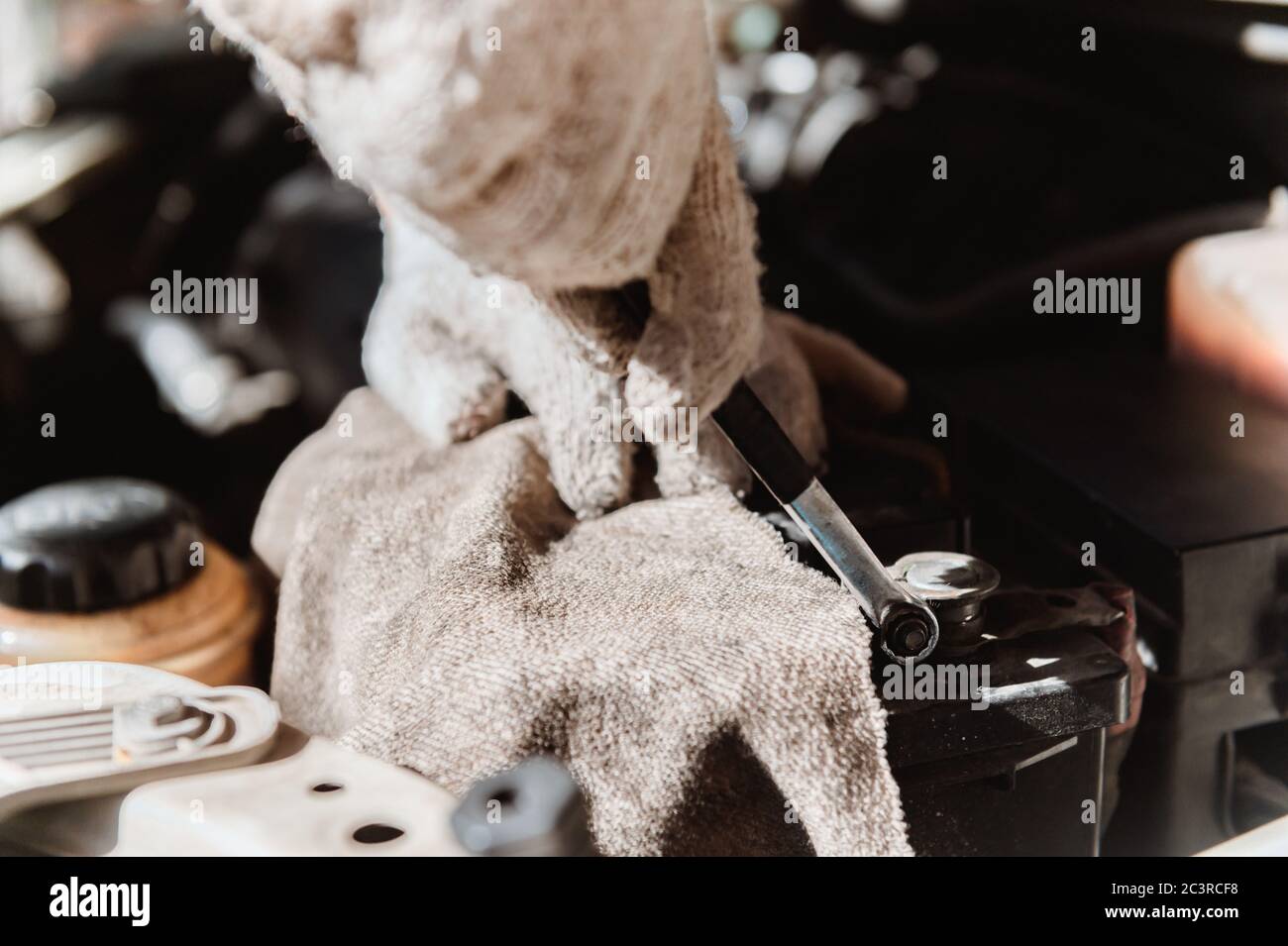 Car maintenance. Men at work from home. Auto mechanic repair engine ...