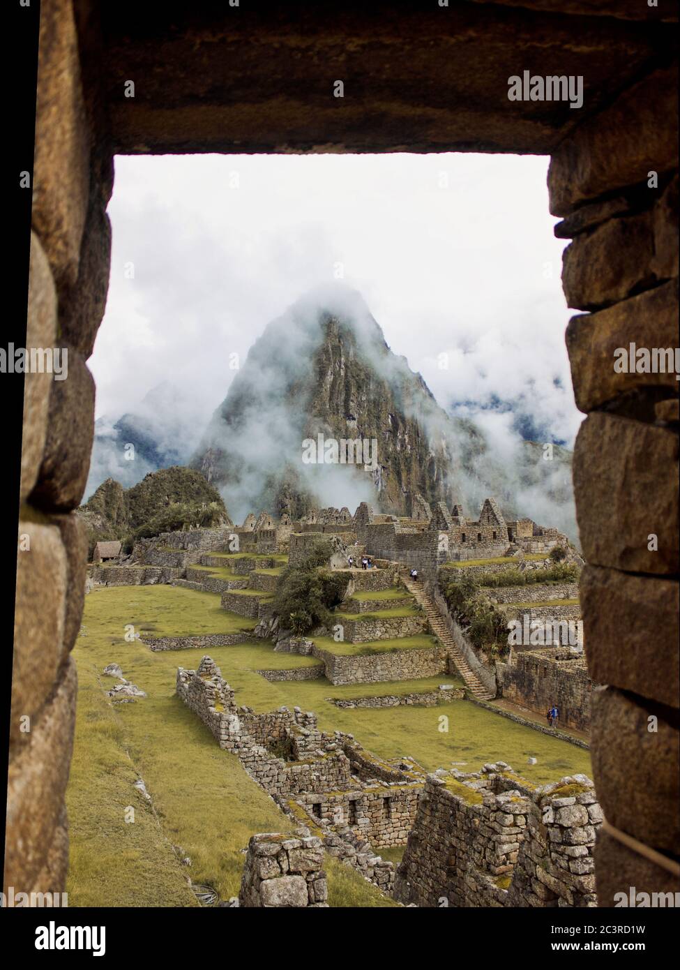 View of mountain peak through the stone door in Machu Picchu Aguas Peru ...