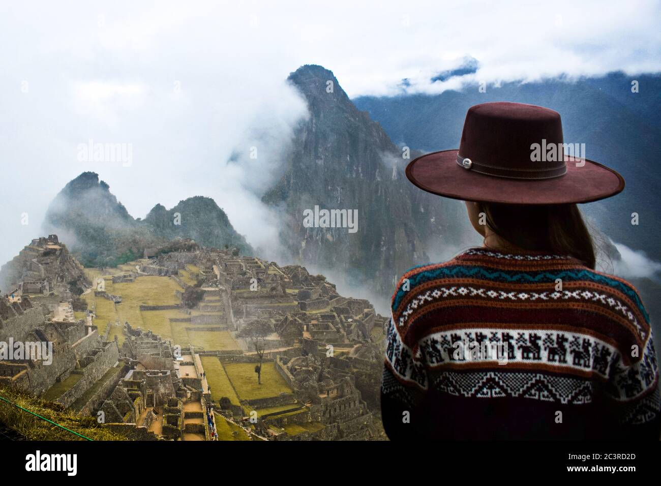 Back view of a girl looking at the scenery of the mountain Machu Picchu ...