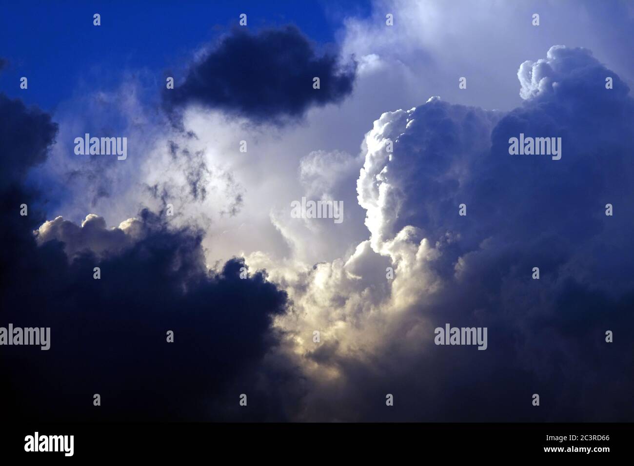 Dark thunder clouds part to reveal sun dappled fluffy pure white clouds ... Dark thunder clouds part to reveal sun dappled fluffy pure white clouds ...