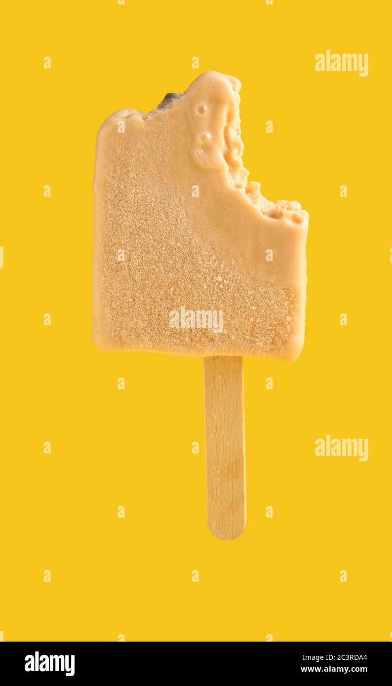 half eaten milk tea flavor popsicle on yellow background Stock Photo ...