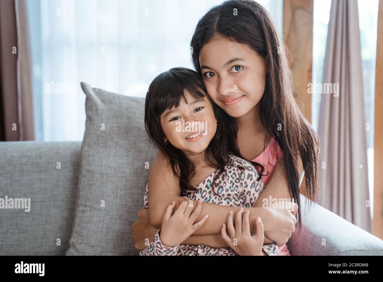 sister embracing each other. kid with older sibling adorable ...