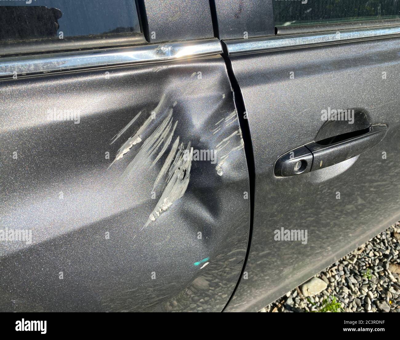The dents on the car door caused by the accident Stock Photo - Alamy
