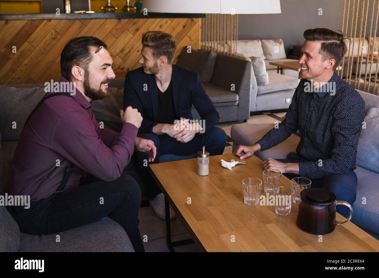 Men drink tea in a stylish loft cafe with a modern design Stock Photo ...