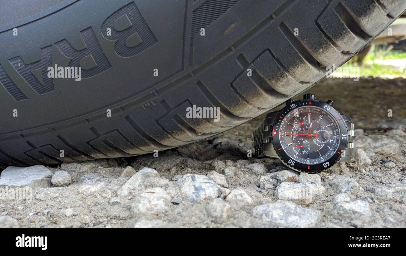 chronograph Tissot under the wheels of a car Krasnodar,Russia-20.06. ...
