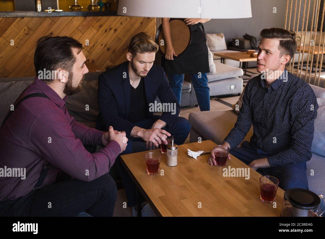Men drink tea in a stylish loft cafe with a modern design Stock Photo ...