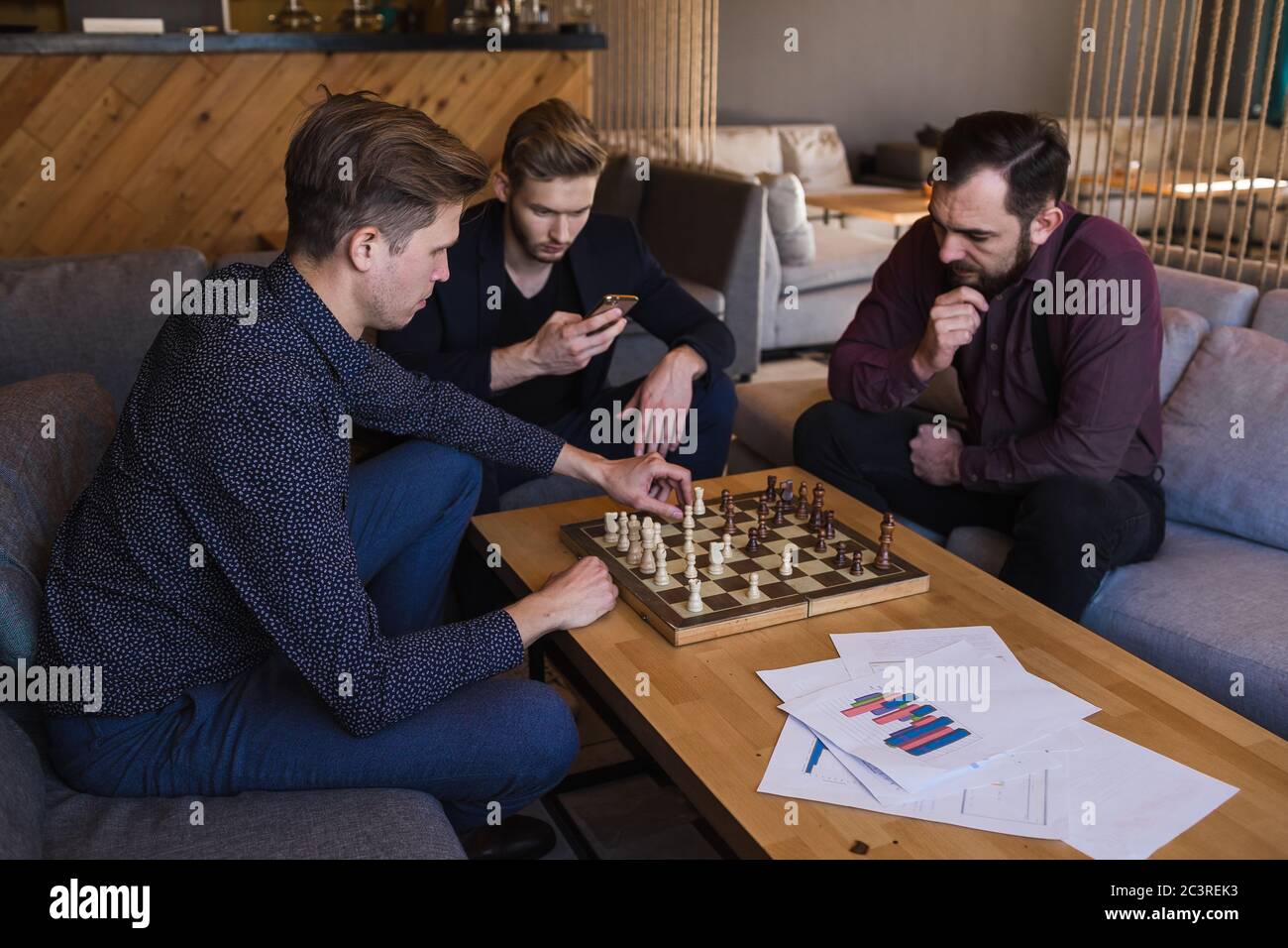 Men play chess in a stylish loft cafe with a modern design Stock Photo ...
