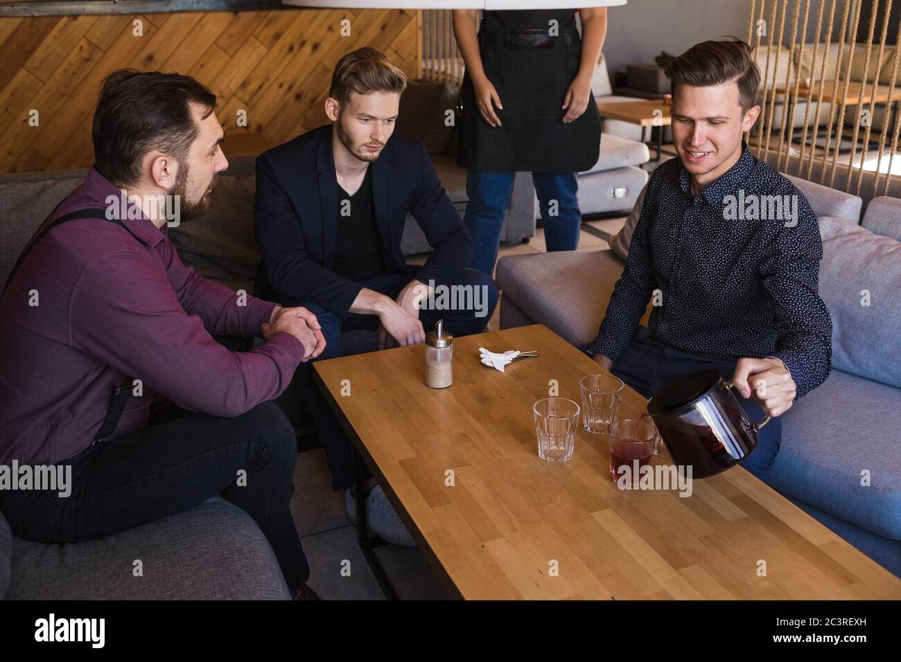 Men drink tea in a stylish loft cafe with a modern design Stock Photo ...