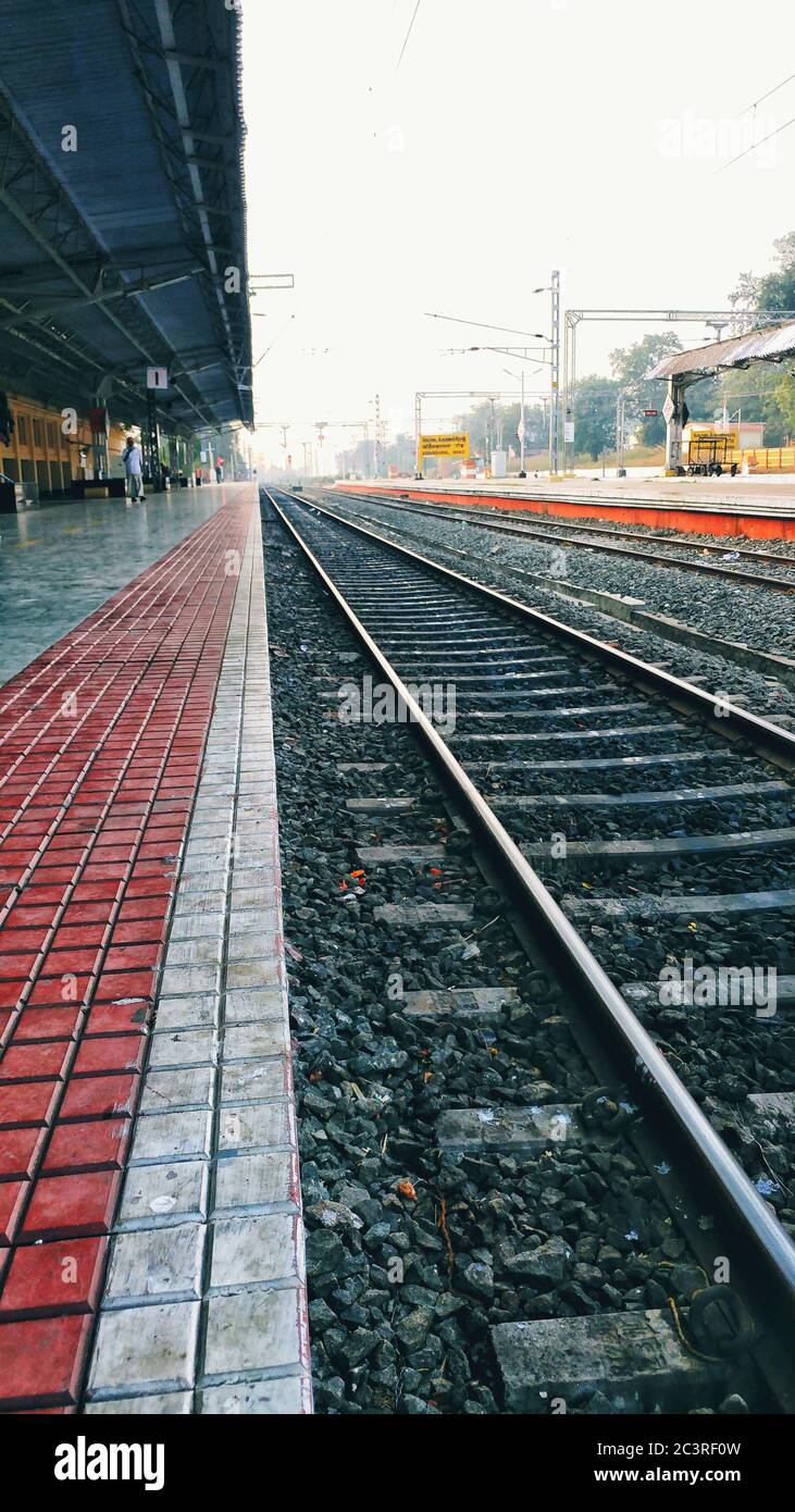 Vertical shot of a railway station - view of the platform Stock Photo ...