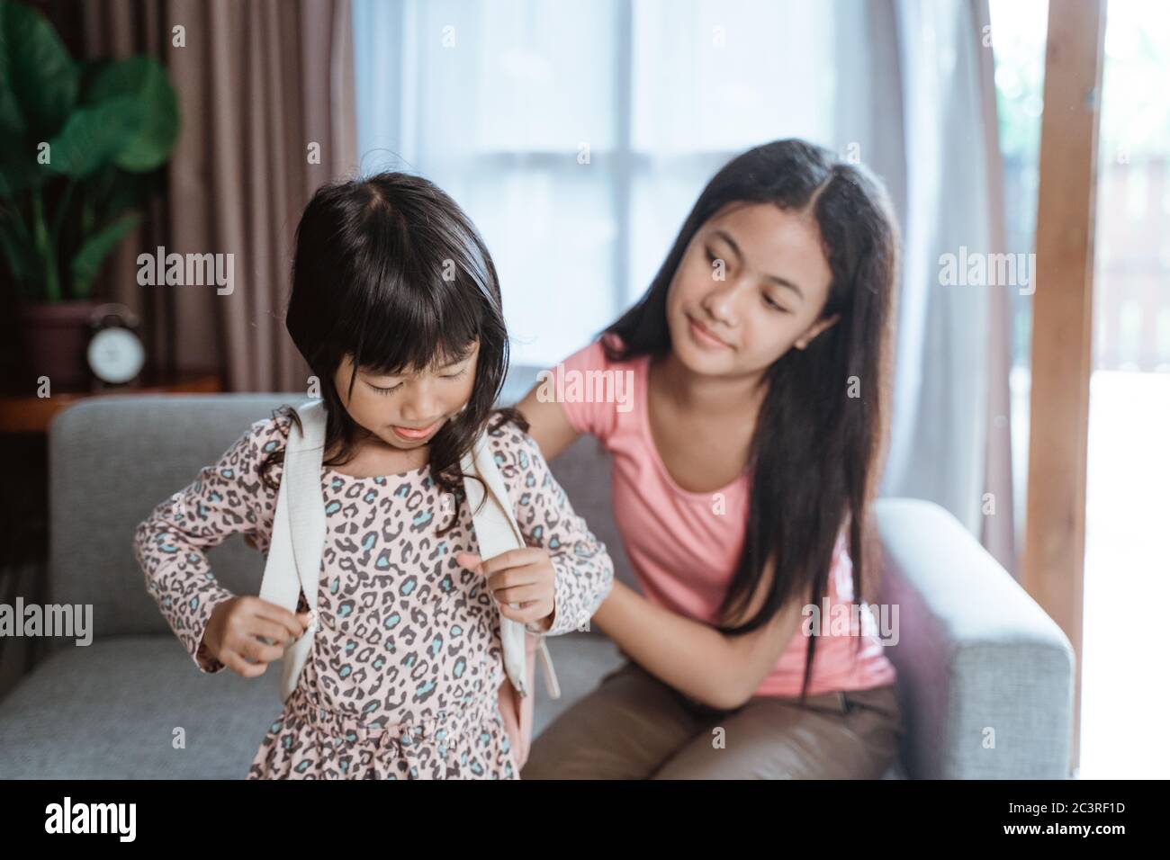 older sister help preparing sibling before going back to school Stock ...