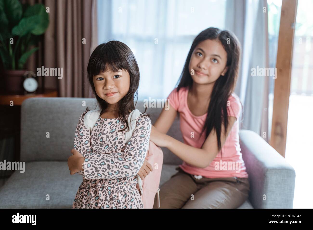 older sister help preparing sibling before going back to school Stock ...