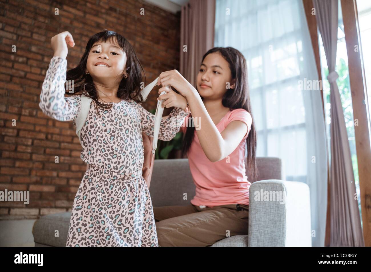 older sister help preparing sibling before going back to school Stock ...
