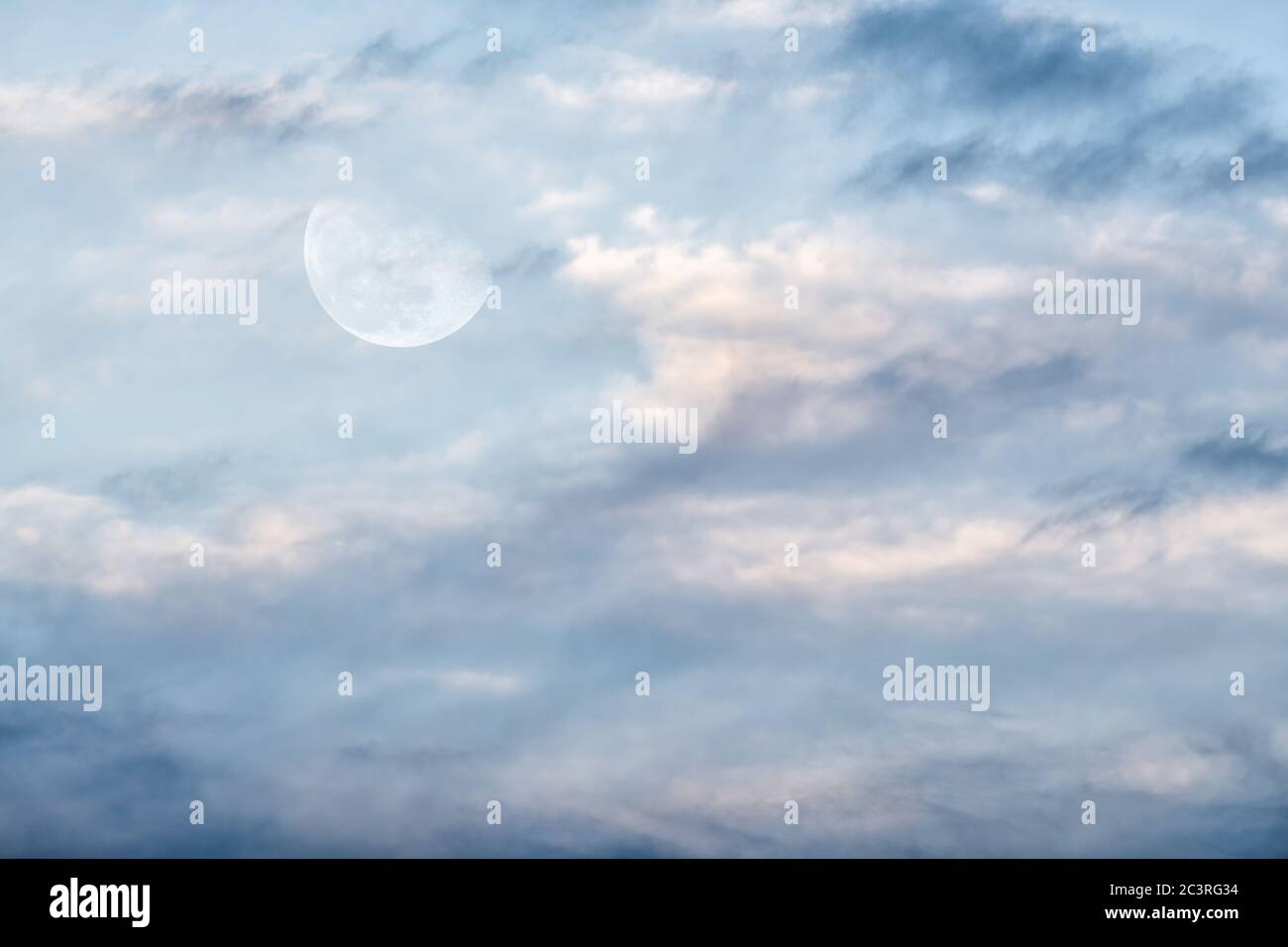 A full Moon is Rising in the Daytime Sky Stock Photo - Alamy