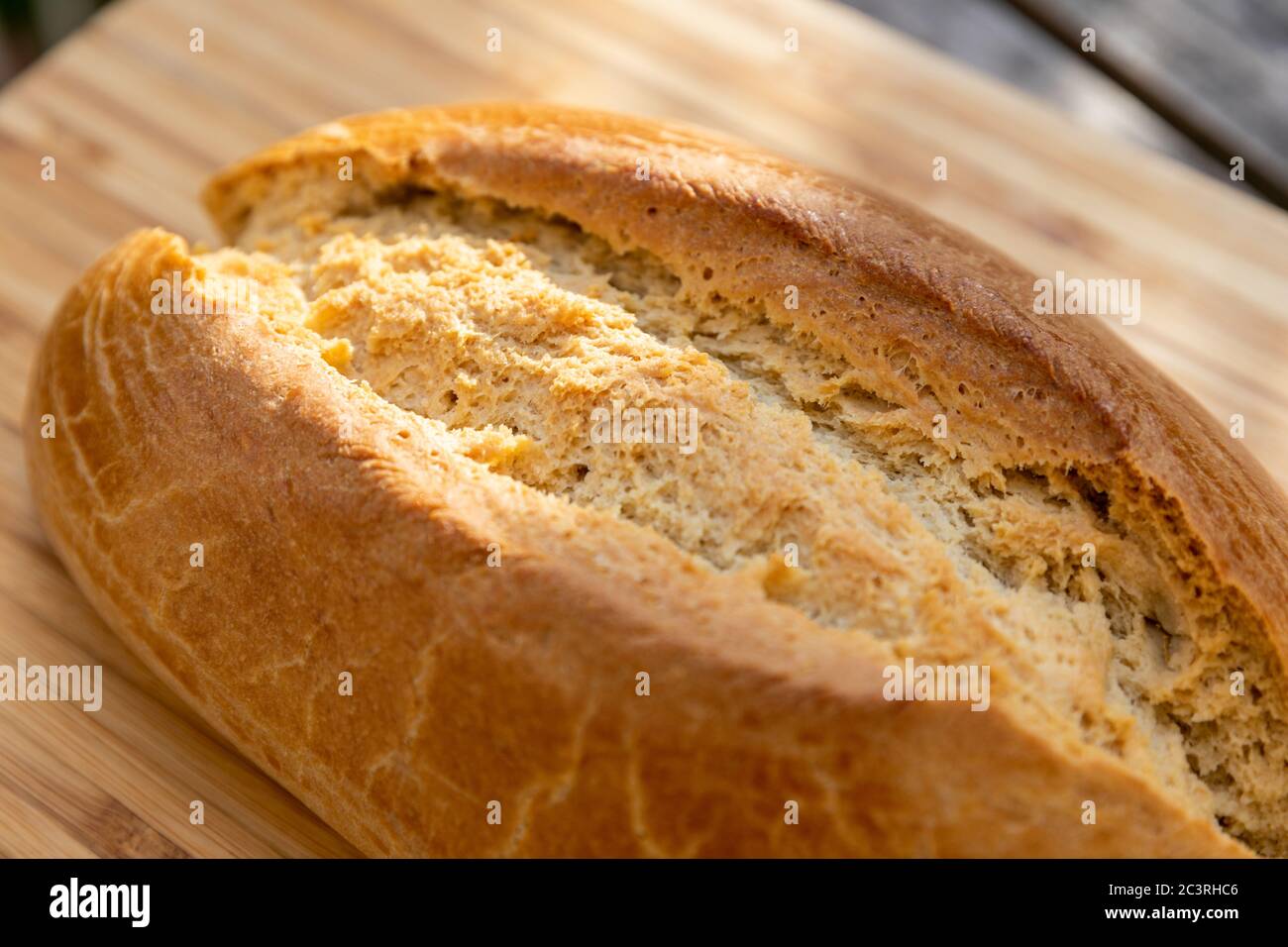 Closeup shot of delicious sourdough bread on a wooden surface under ...