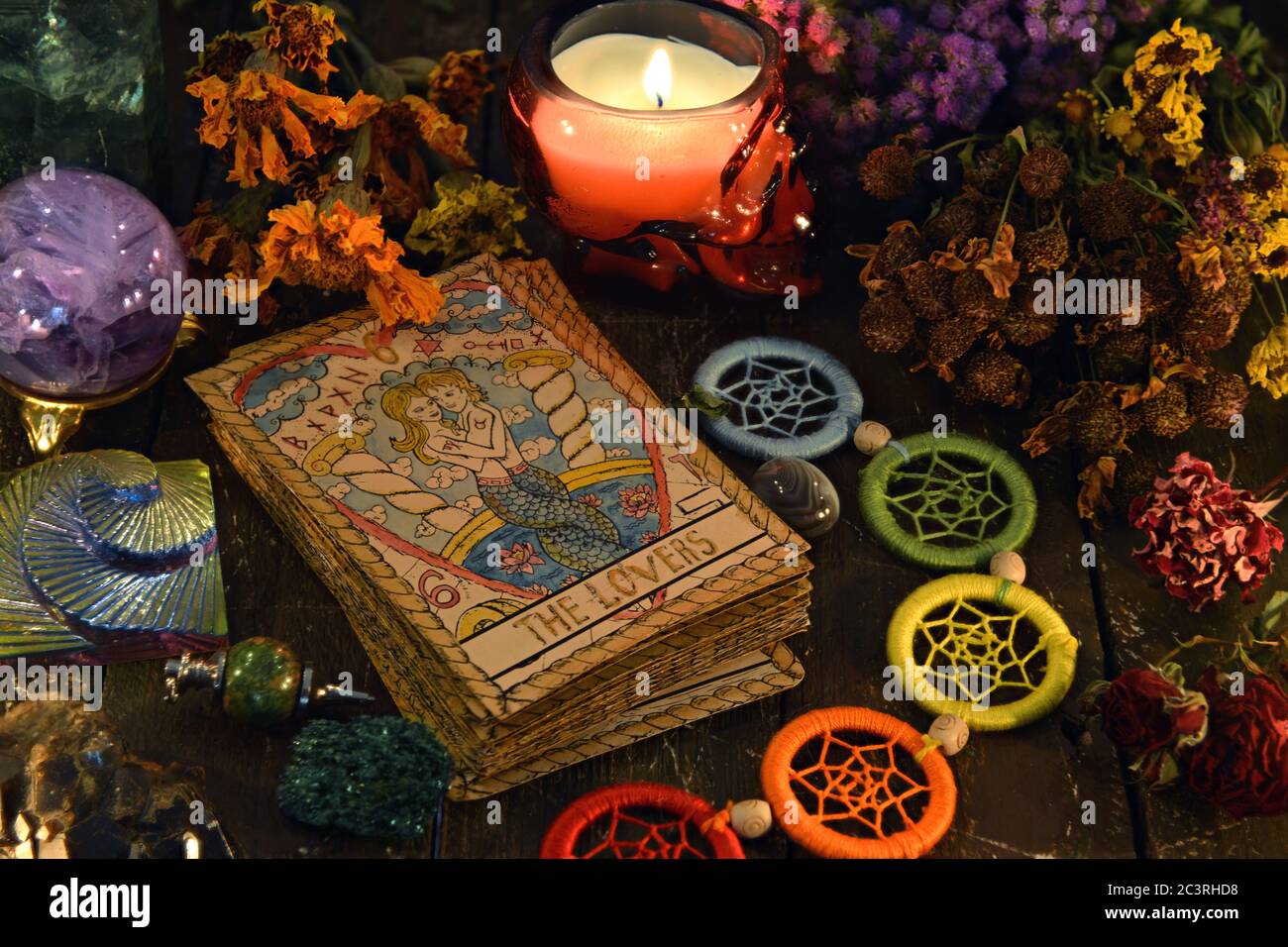 Tarot cards with chakra decorations, herbs and burning candle. Wicca ...