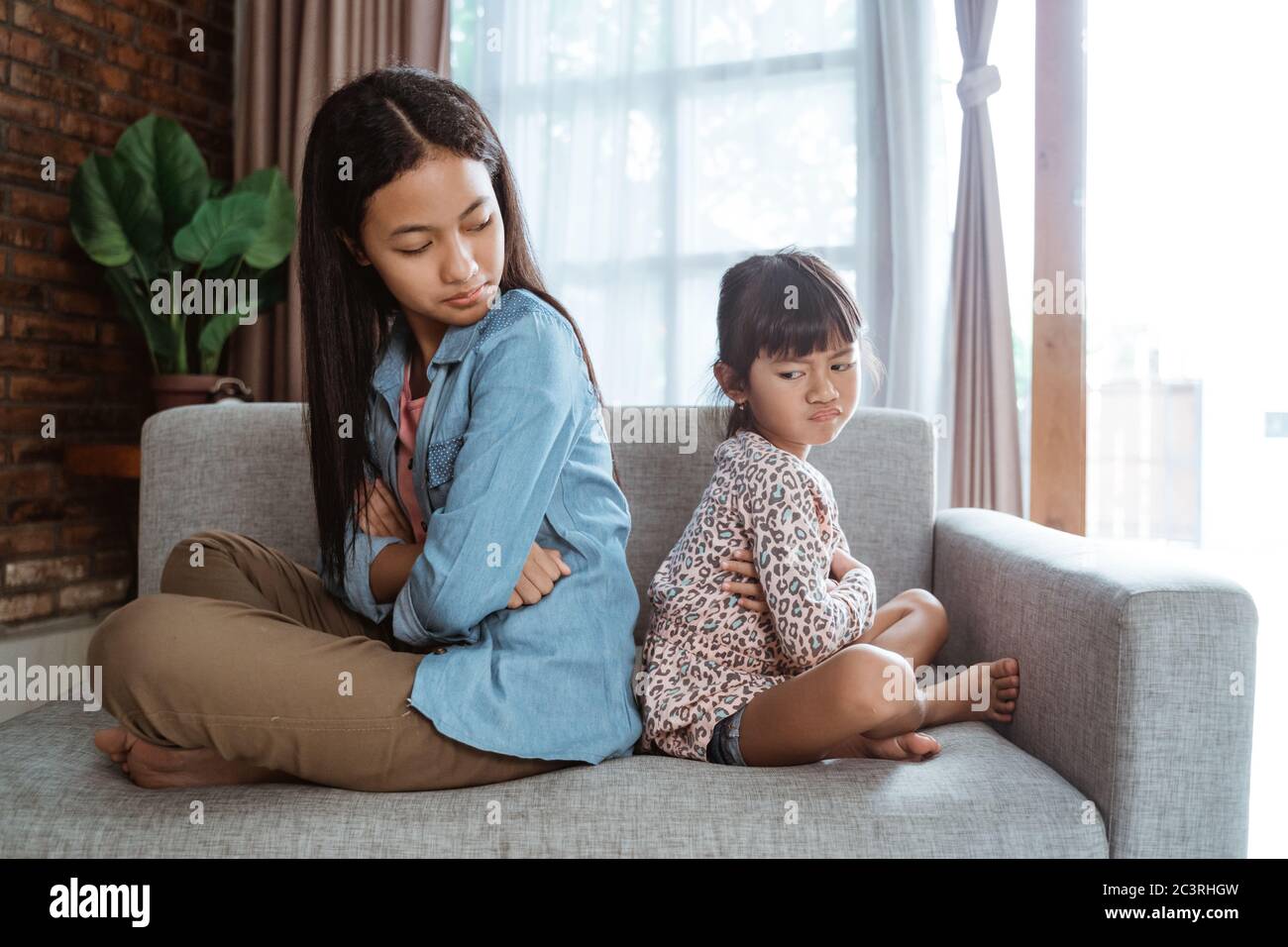 sibling different age fighting each other at home Stock Photo - Alamy