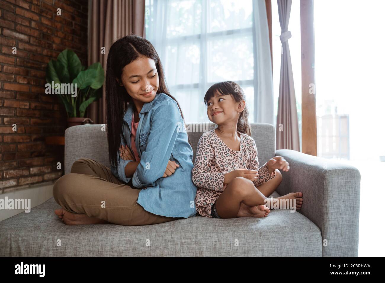 sibling different age fighting each other at home Stock Photo - Alamy