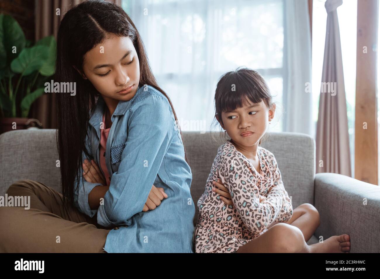 sibling different age fighting each other at home Stock Photo - Alamy