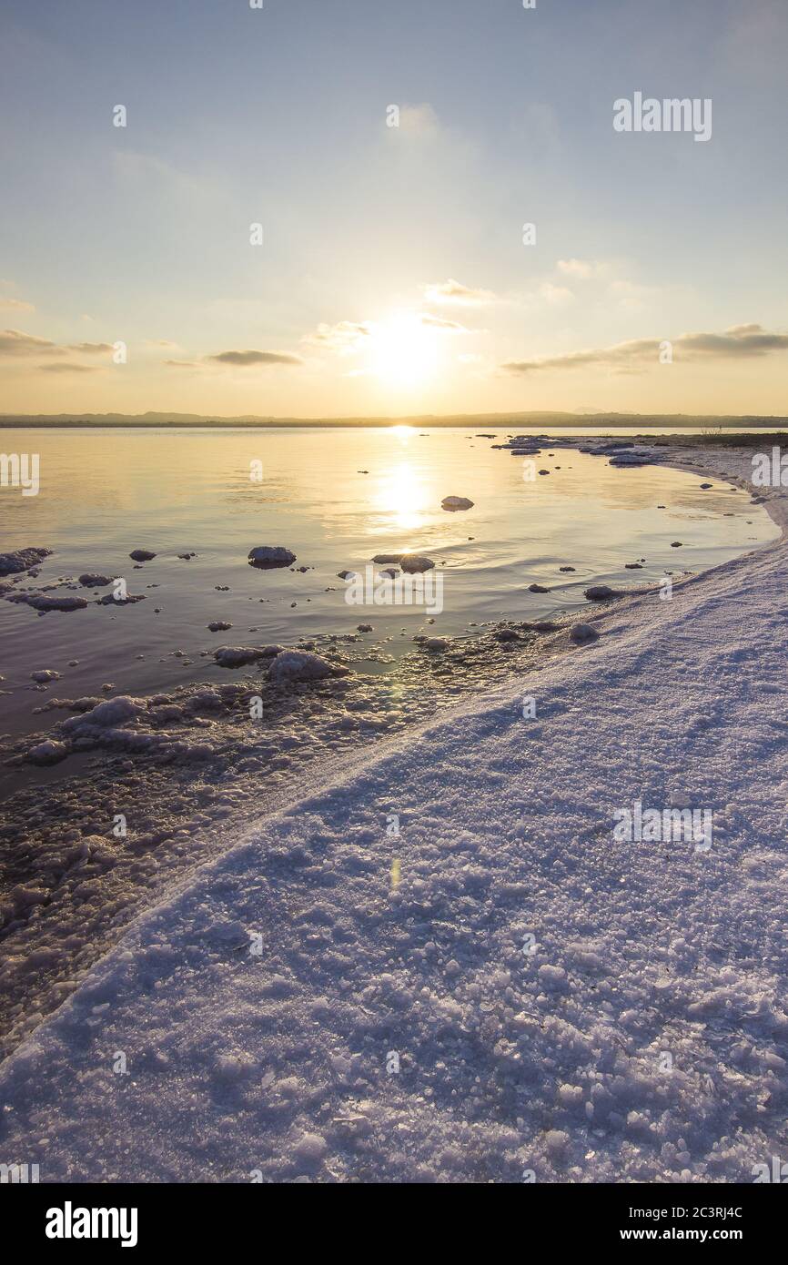 Beautiful scenery of a salty beach during a sunrise Stock Photo - Alamy