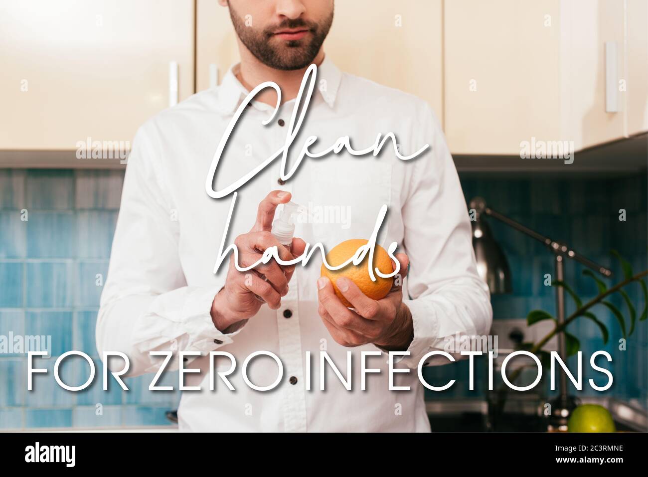 Cropped view of man disinfecting orange with hand sanitizer in kitchen ...
