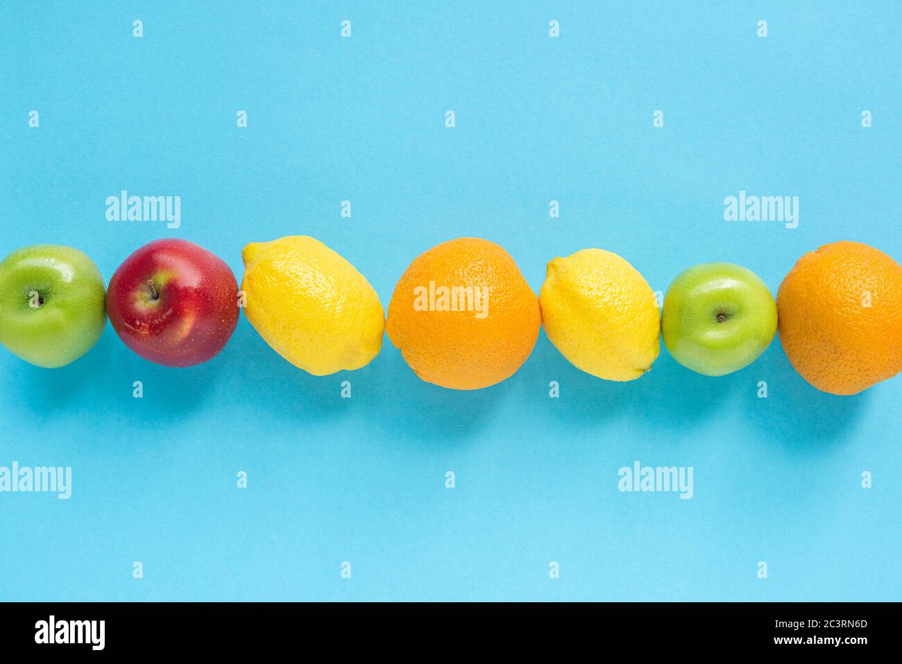 top view of ripe fruits in line on blue background Stock Photo - Alamy