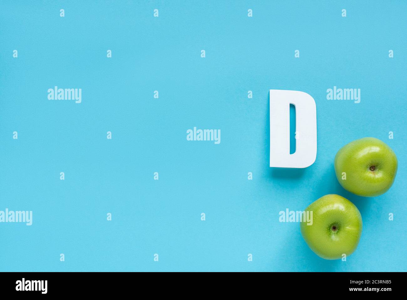 top view of ripe green apples and letter D on blue background Stock ...
