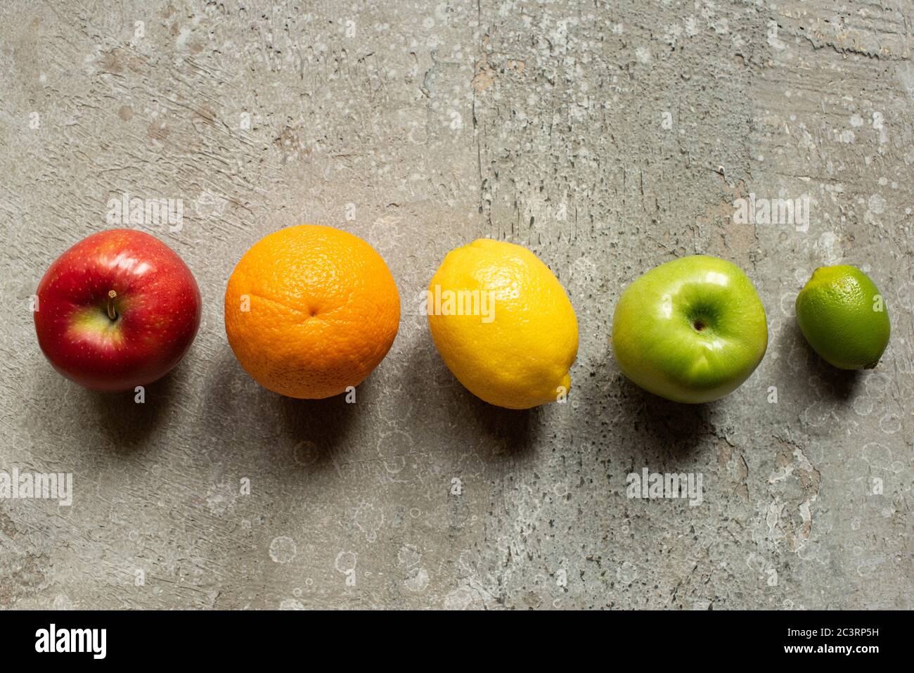 top view of tasty colorful fruits on grey concrete surface Stock Photo ...