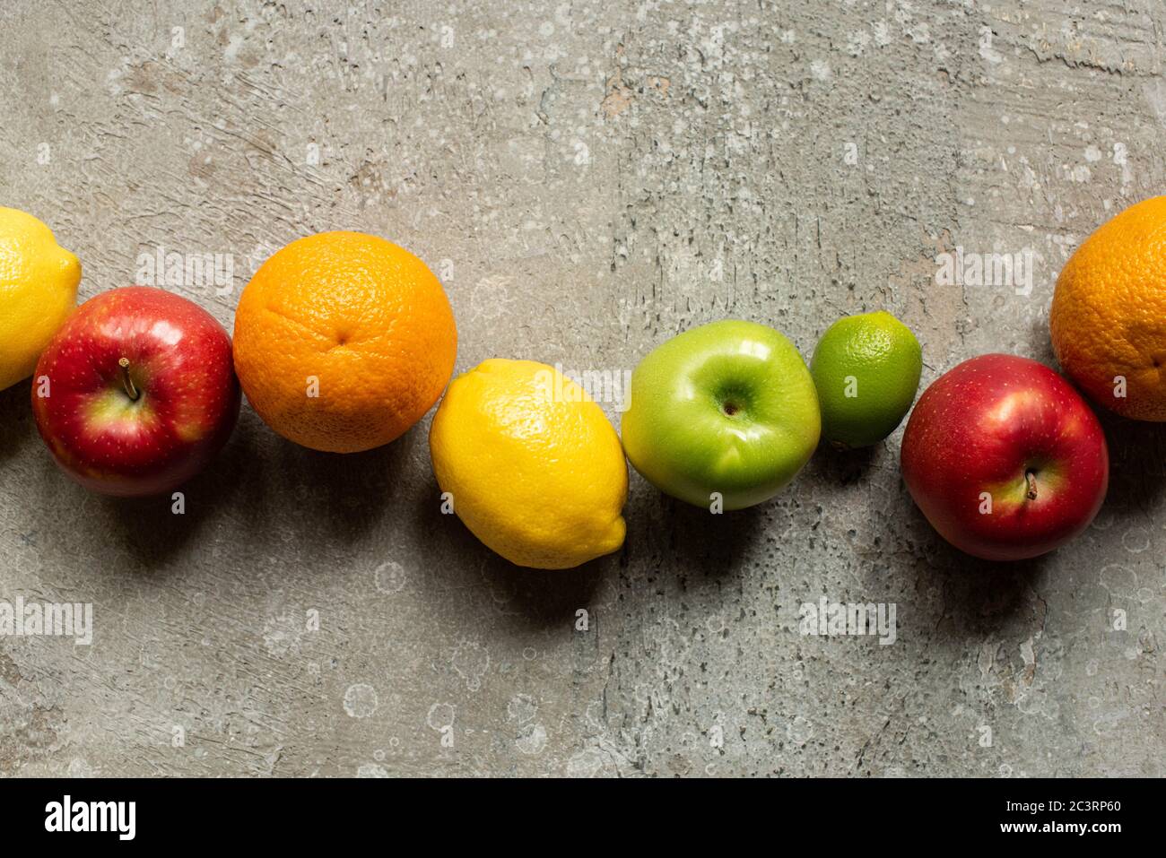 top view of tasty colorful fruits on grey concrete surface Stock Photo ...
