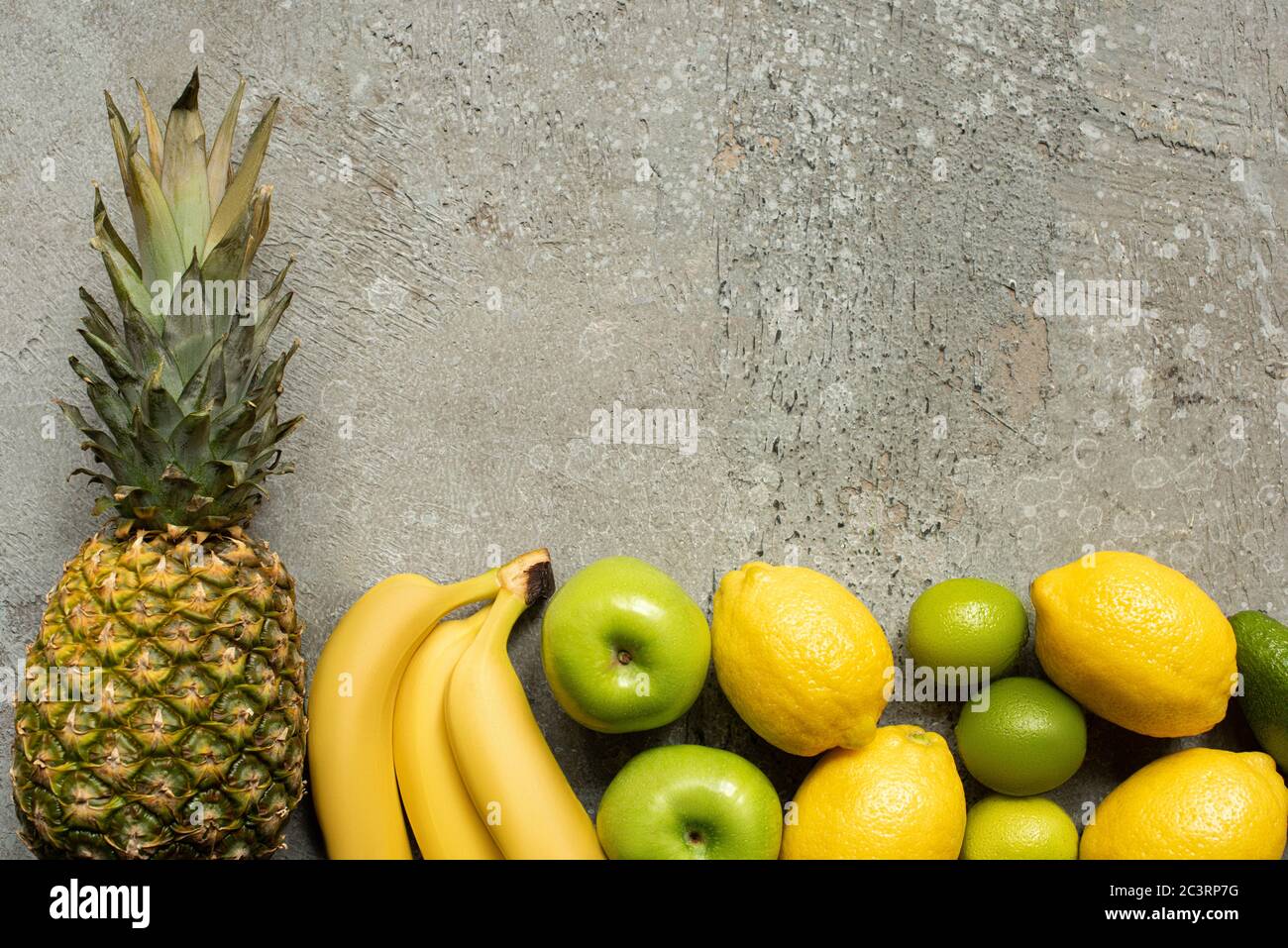 top view of colorful fresh fruits on grey concrete surface Stock Photo ...