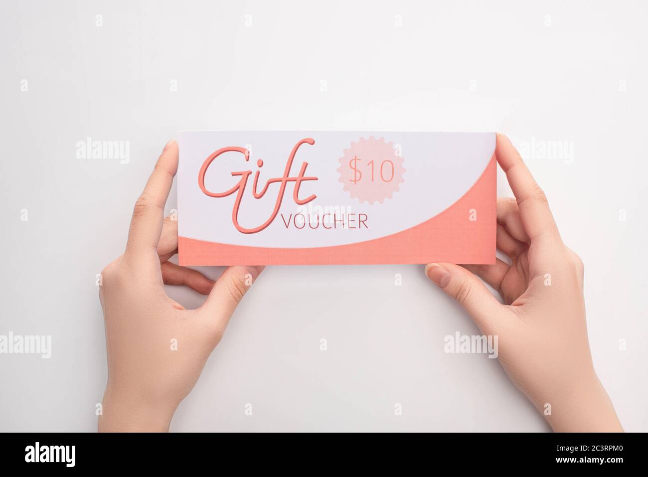 Top view of woman holding gift voucher with 10 dollars sign on white ...