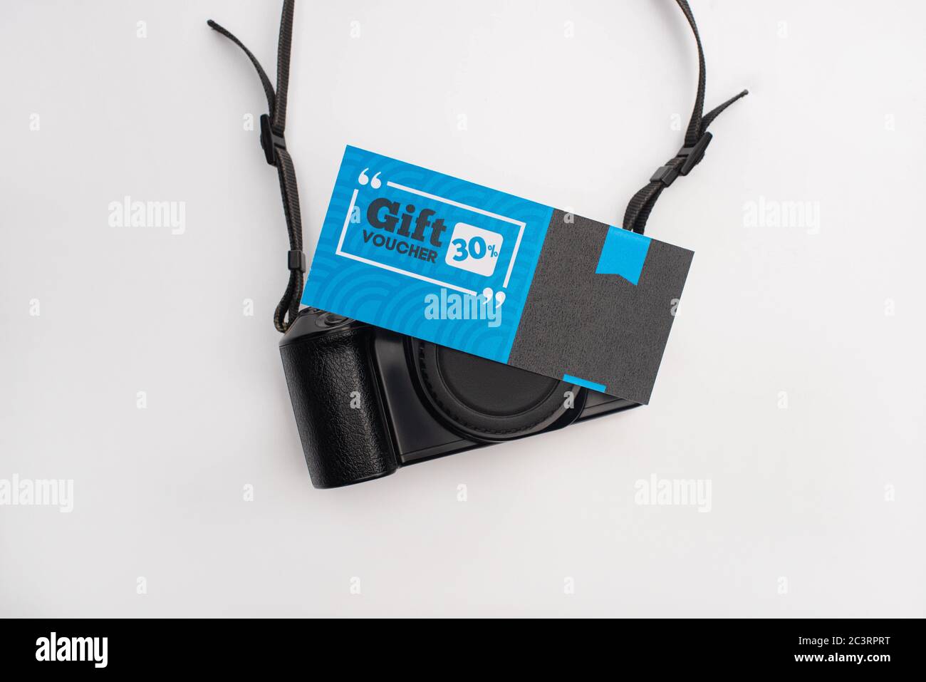 Top view of gift voucher with 30 percents sign on digital camera on ...