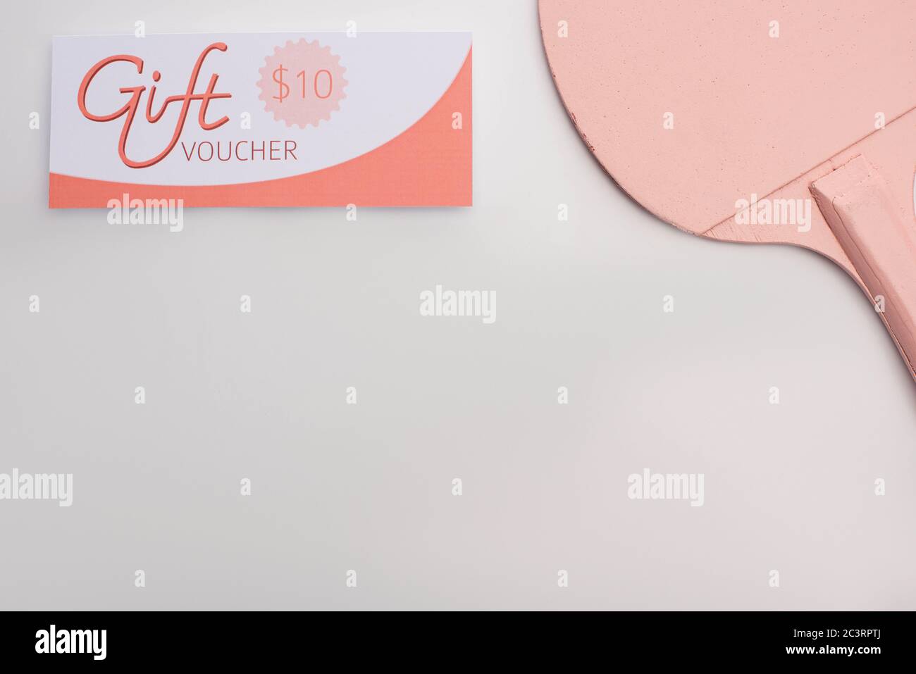 Top view of ping pong racket on gift voucher on white background Stock ...