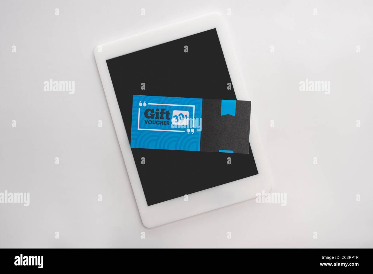 Top view of gift voucher with 30 percents sign on digital tablet on ...