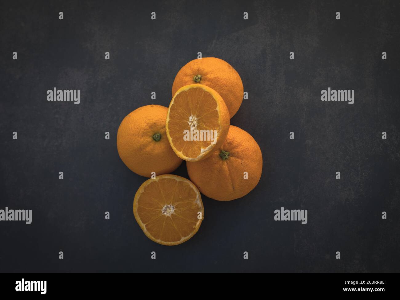 Closeup shot of orange fruits bunch on a black surface Stock Photo - Alamy