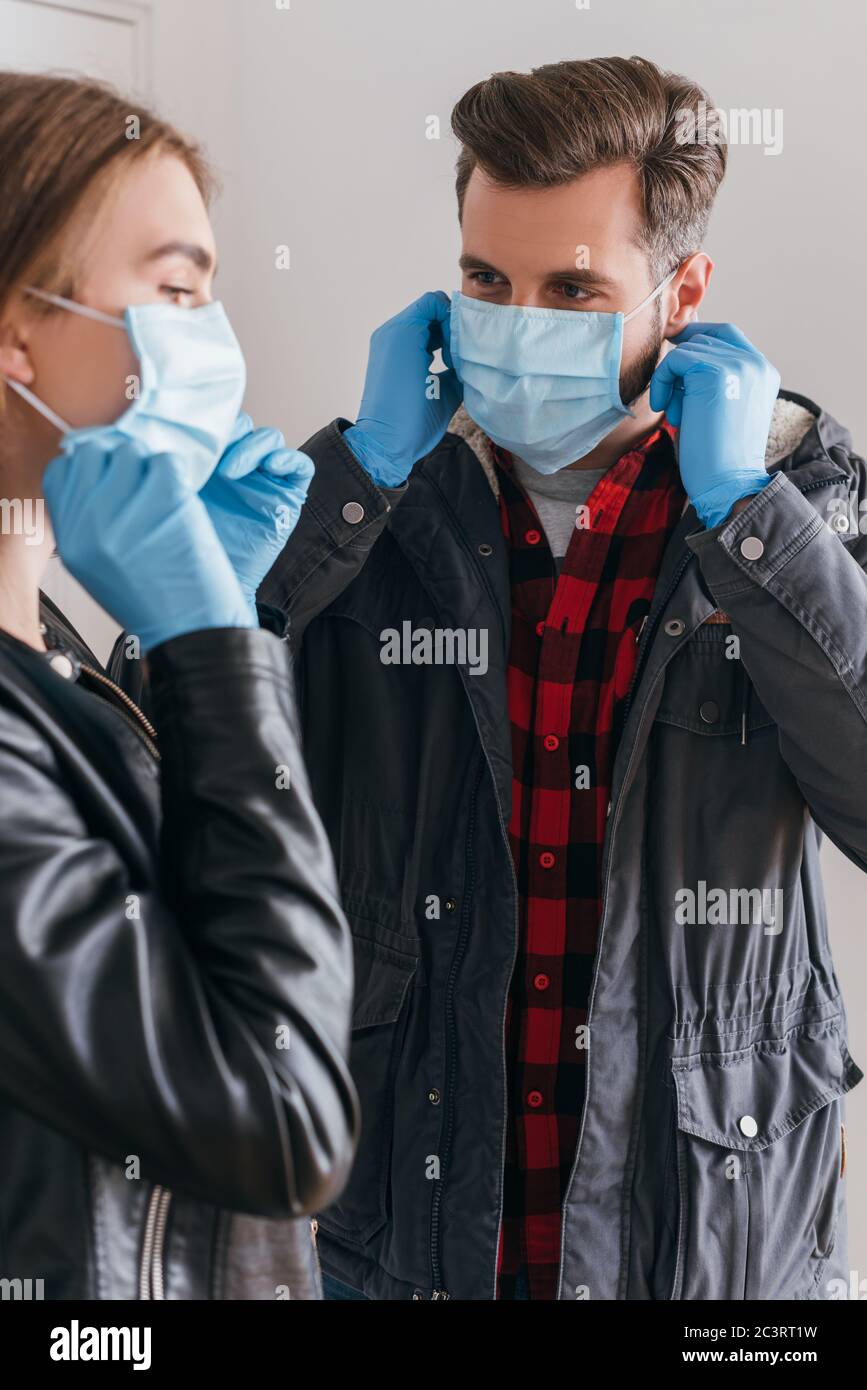 Putting on protective masks hi-res stock photography and images - Alamy