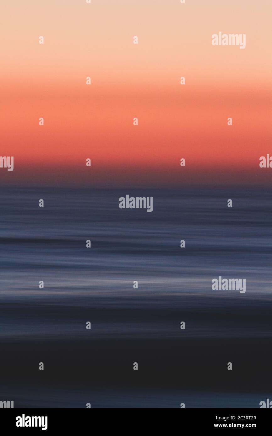 Breathtaking shot of the reflection of a colorful sunset with long ...