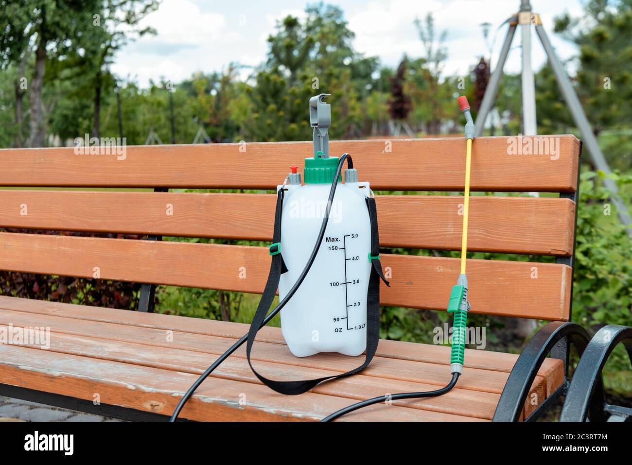 spray bag with disinfectant standing on bench in park during covid-19 ...