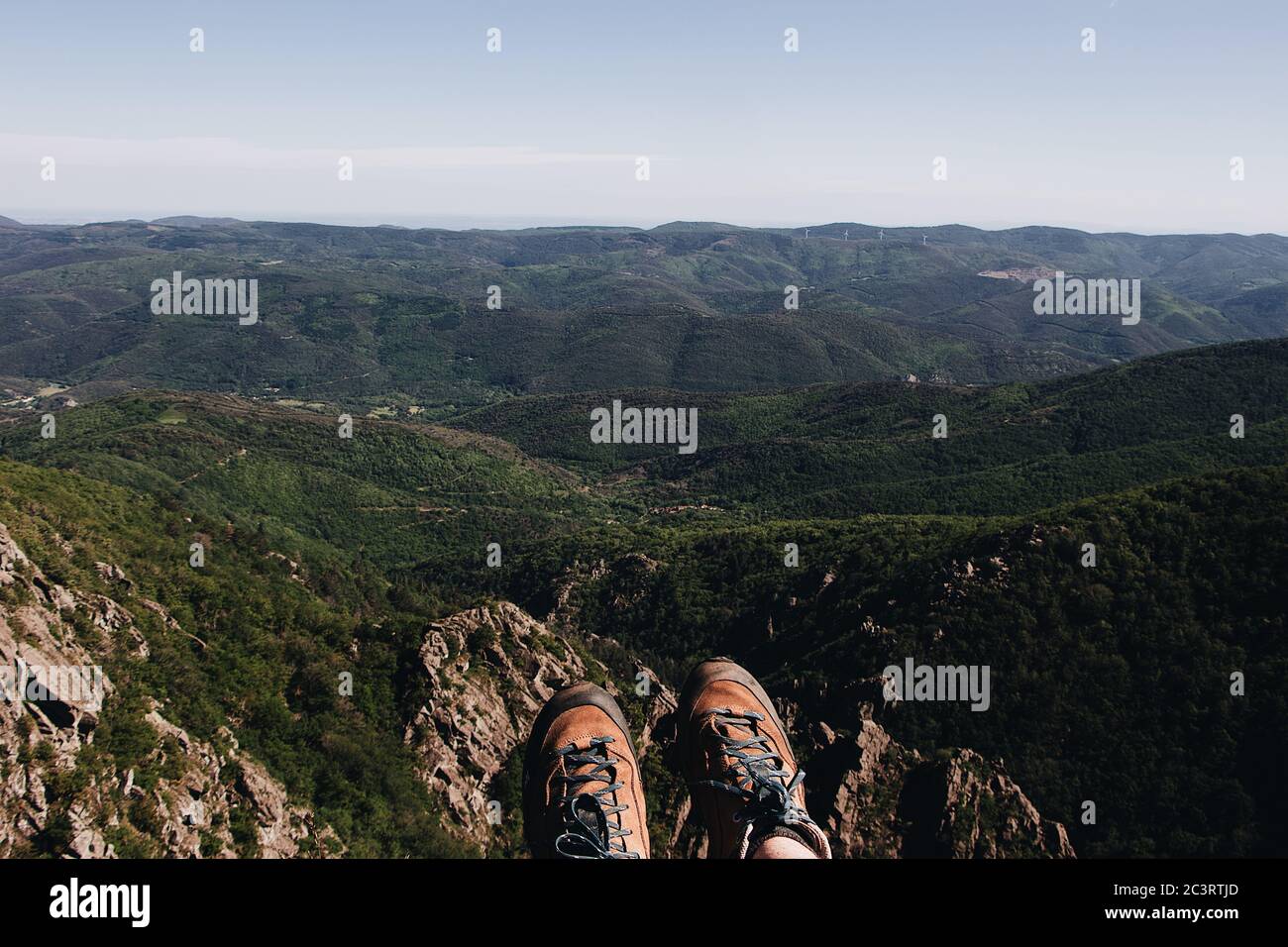 High angle shot of a person's feet hanging from the edge overlooking ...