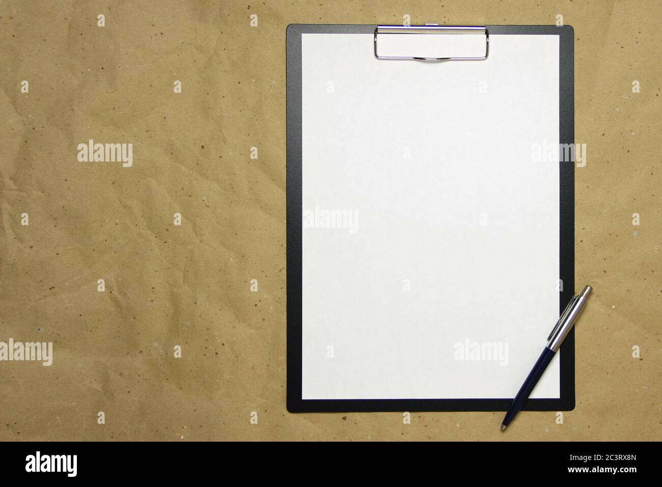 A tablet with a white sheet of A4 format on a beige craft paper. Stock ...