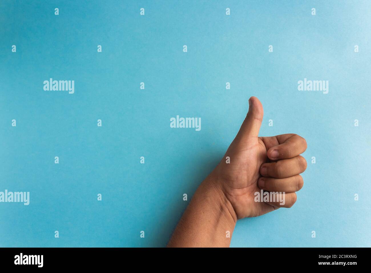 Closeup shot of a human hand with a thumb up- perfect for ok, okay ...