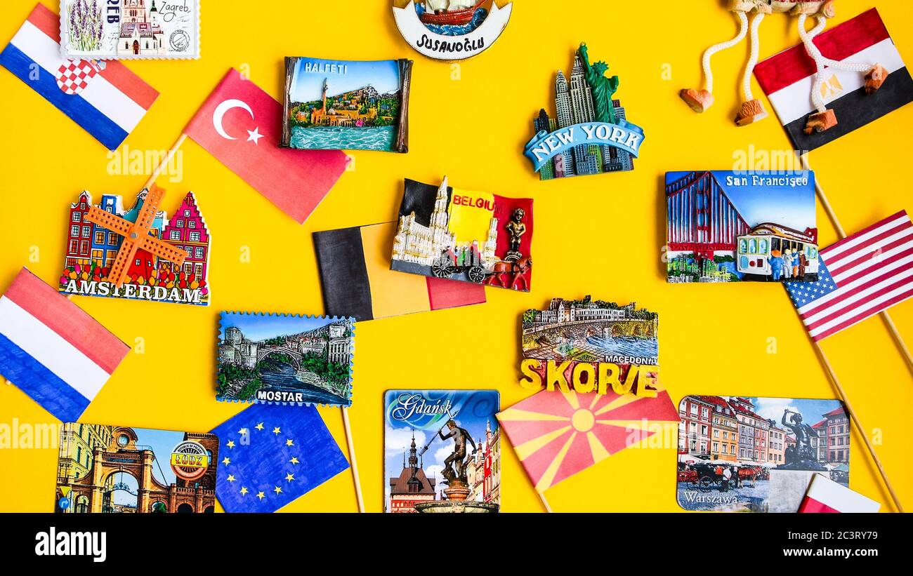 Magnets from different countries with flags on yellow background ...